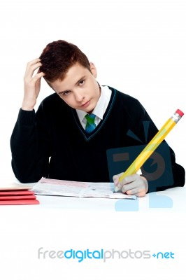 Confused Schoolboy Writing Stock Photo - Royalty Free Image ID 100102422