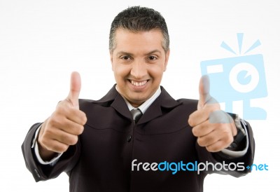 Front View Of Smiling Boss Showing Thumb Up With Both Hands Stock Photo ...
