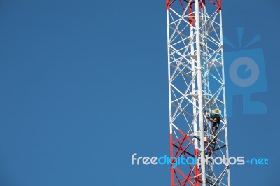 Man On telecommunication Tower Stock Photo - Royalty Free Image ID 10091011