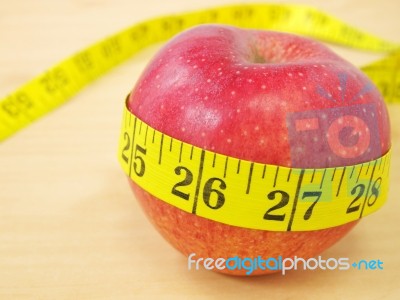 Measuring Tape Around Apple Stock Photo - Royalty Free Image ID 10042494