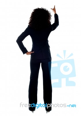 Rear View Of Lady Pointing up Stock Photo - Royalty Free Image ID 10092747