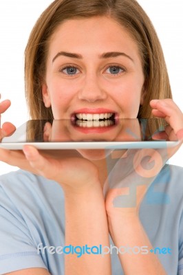 Teenage Girl Biting Tablet Pc Stock Photo - Royalty Free Image ID 100105726